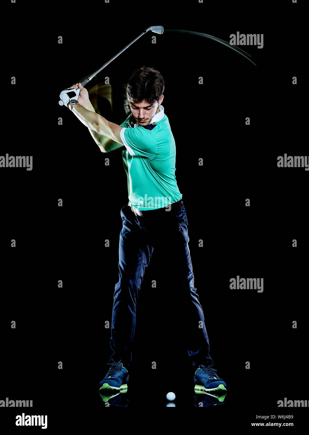 one caucasian young golfer man golfing golf swing isolated on black ...