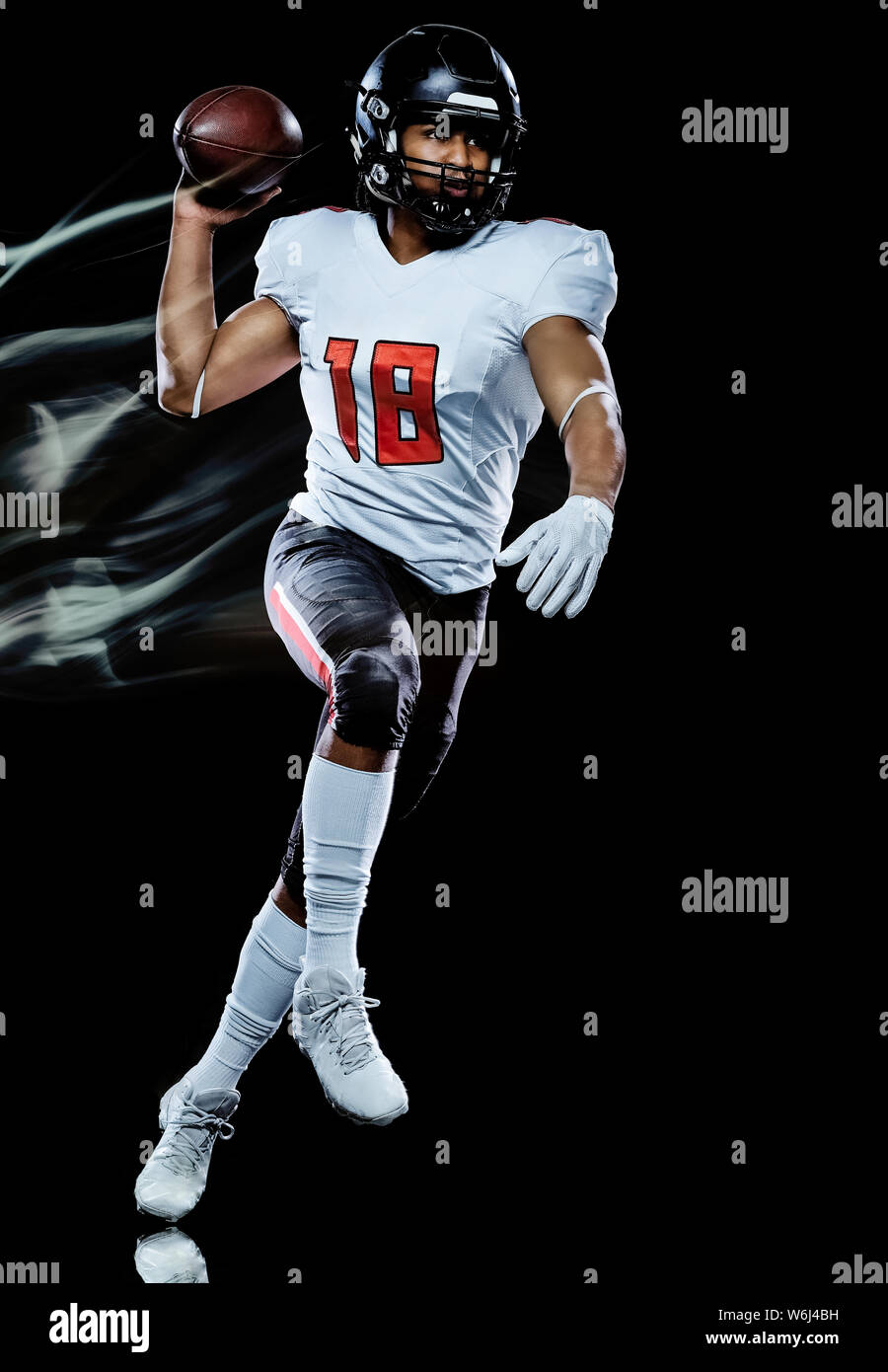 one african american football player man studio shot isolated on black ...