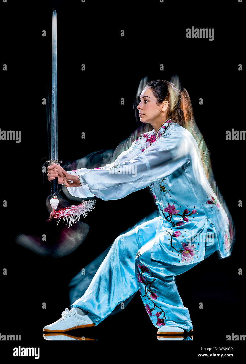 one chinese woman partacticing Tai Chi Chuan Tadjiquan posture studio ...