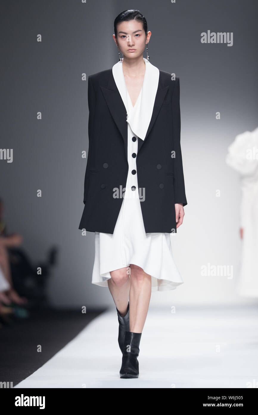 A model displays a new creation at the fashion show of Anirac during the Shanghai Fashion Week ...