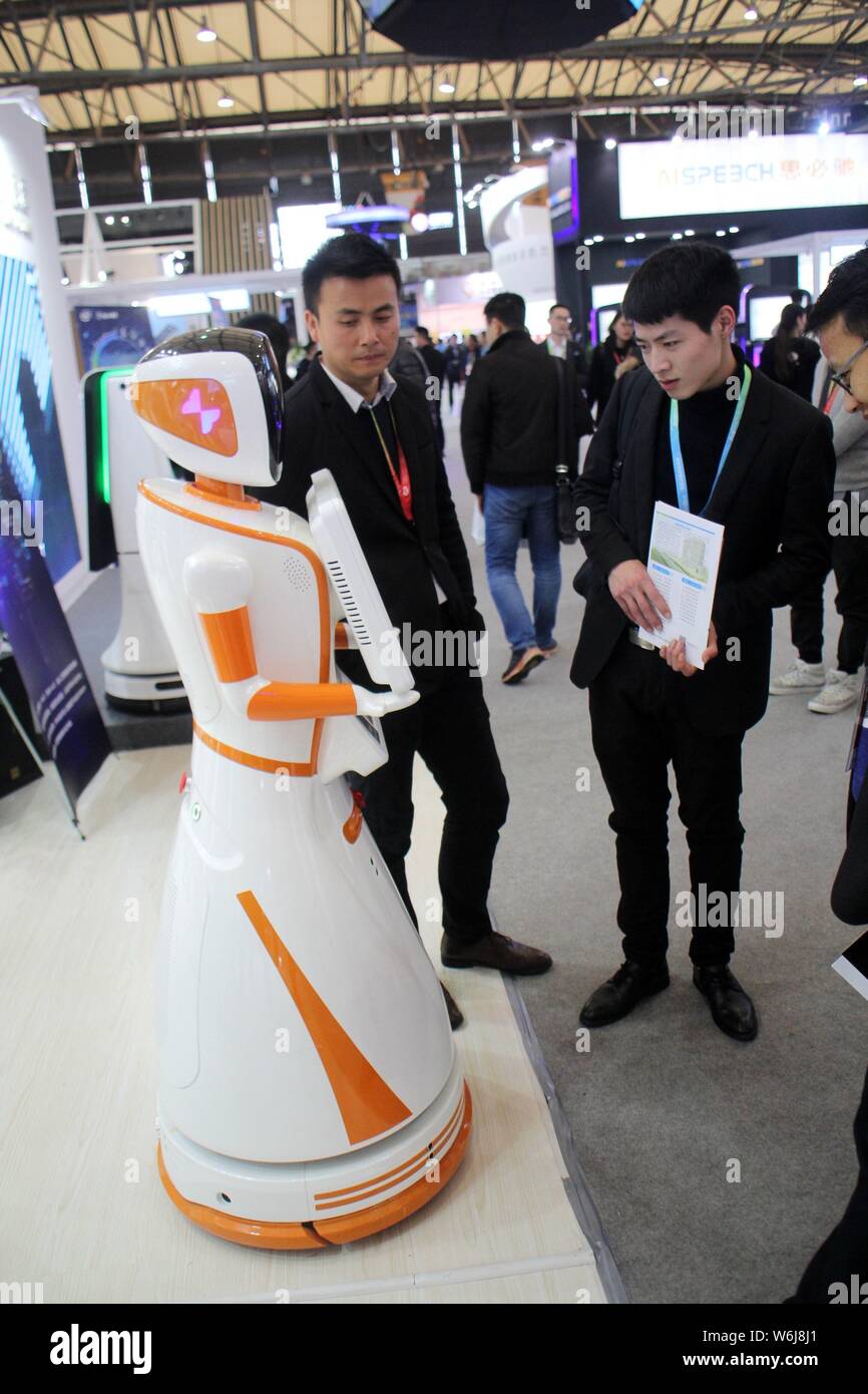 Visitors look at AI robots during the Appliance & Electronics World Expo 2018 (AWE2018) at ...