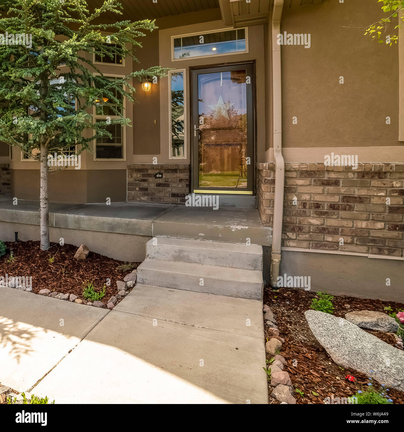 Square frame Home facade with view of yard garage door porch and front ...