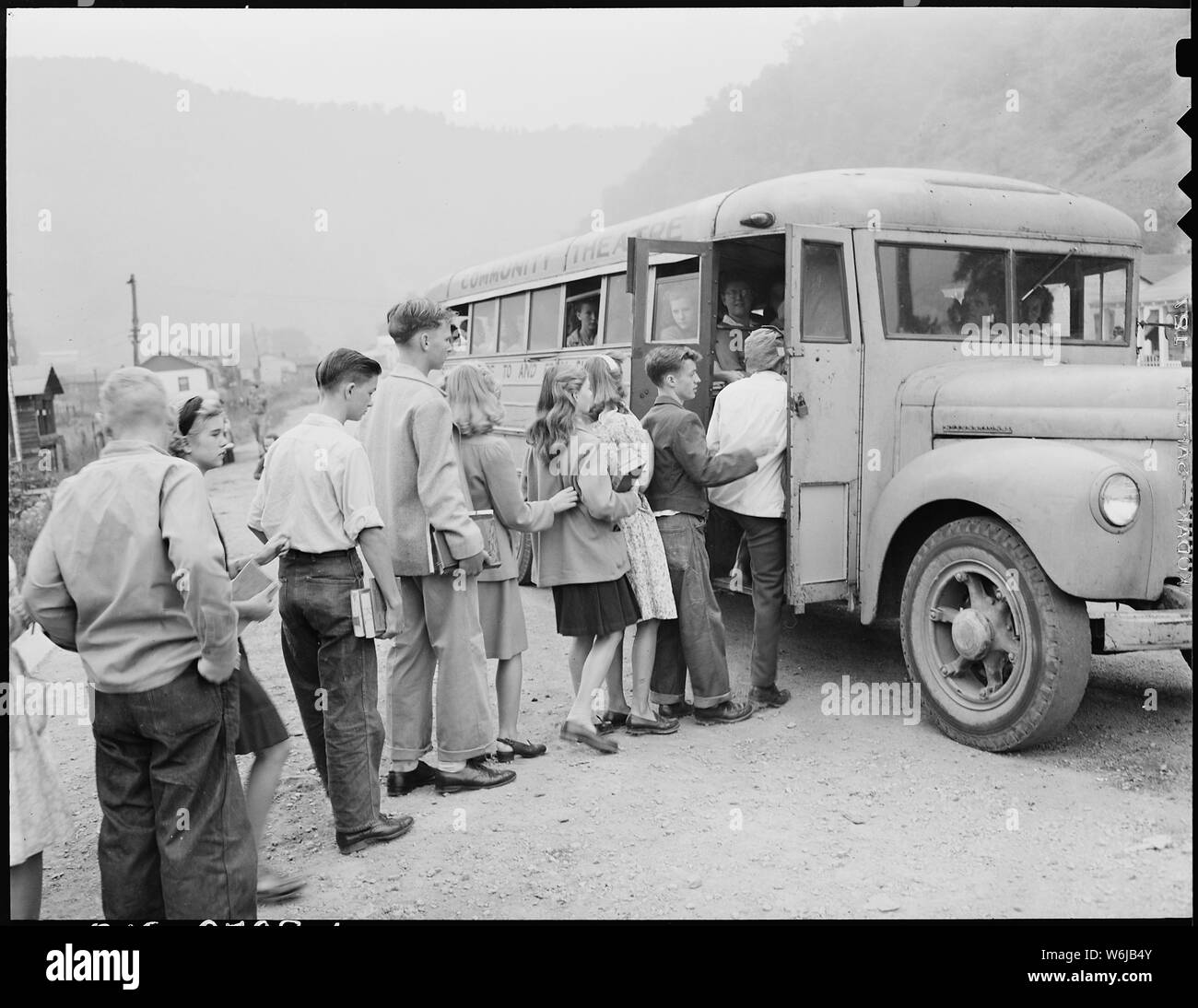 Louis Sergent, the tallest boy in a sport jacket, catches the bus which ...