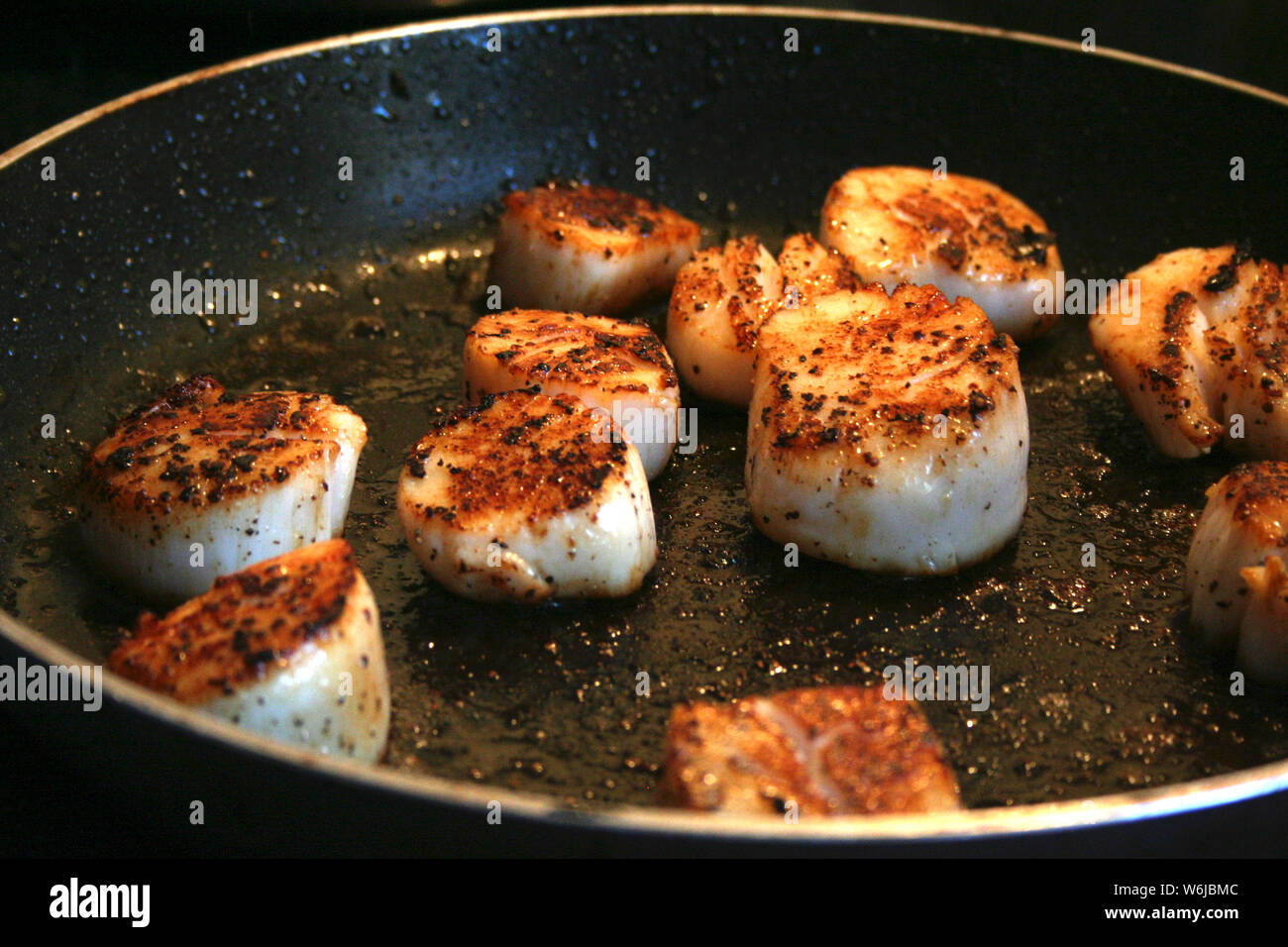Fried cooked scallops seasoned with salt pepper and spice Stock Photo ...