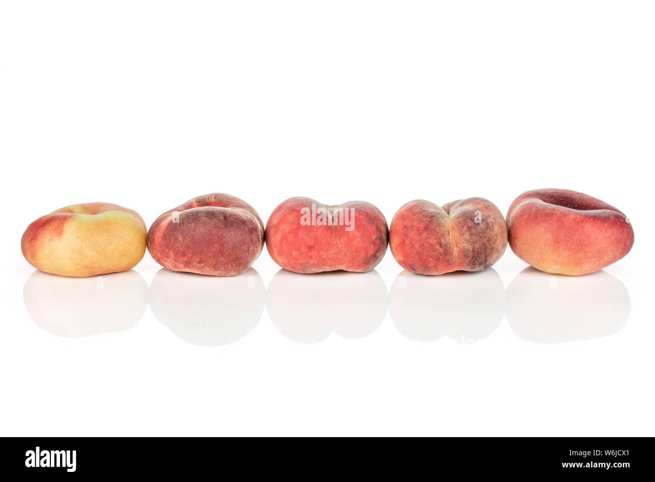 Group of five whole fresh red peach prunus persica platycarpa in row ...