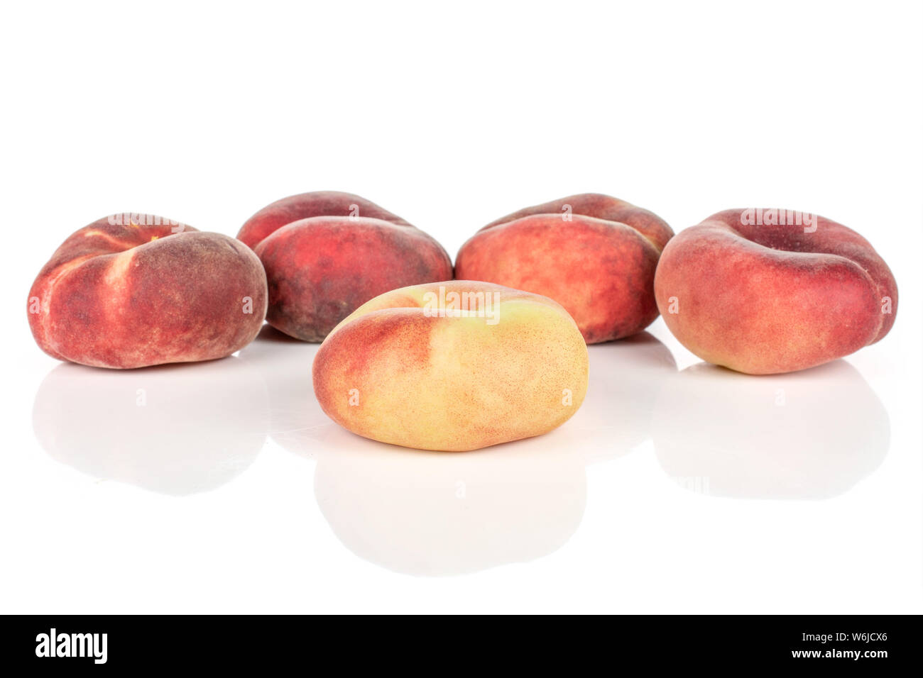 Group of five whole fresh red peach prunus persica platycarpa isolated ...