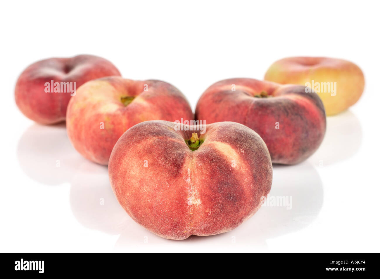 Group of five whole fresh red peach prunus persica platycarpa arranged ...