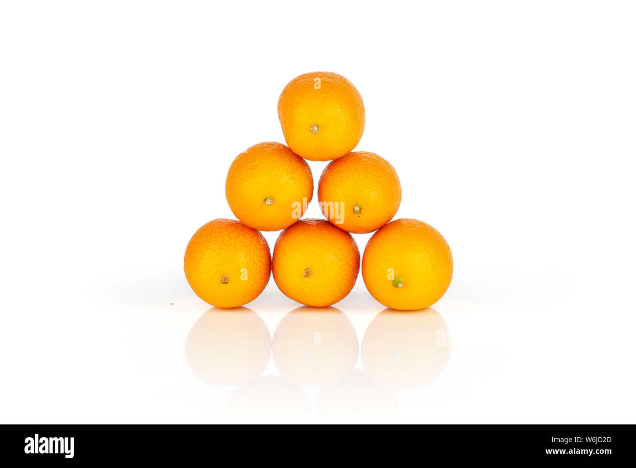 Group of six whole fresh orange kumquat arranged in a pyramid isolated ...