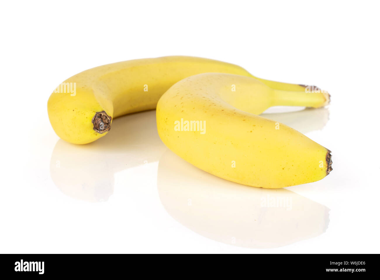 Group of two whole ripe yellow banana isolated on white background ...