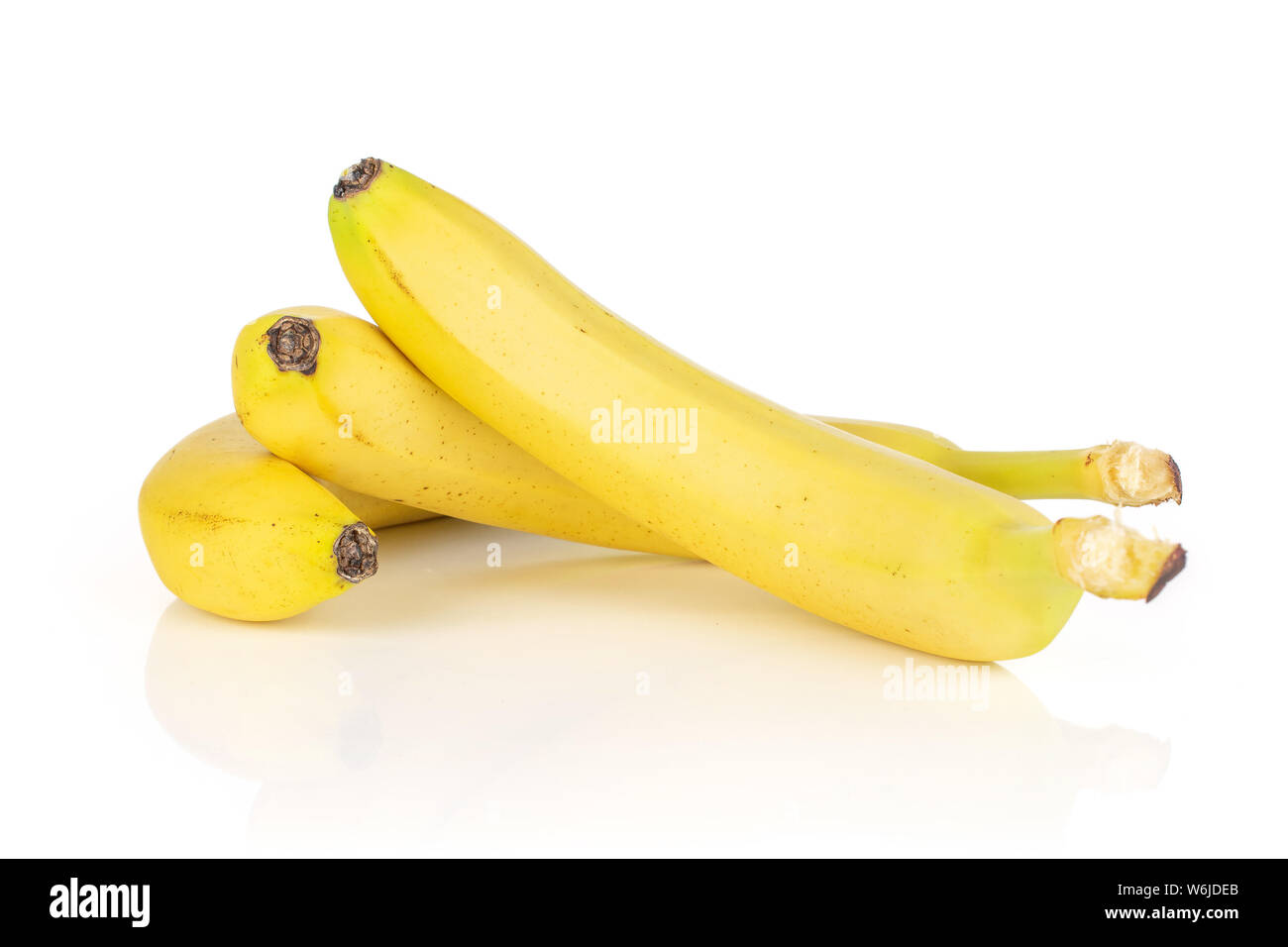 Group of three whole ripe yellow banana isolated on white background ...