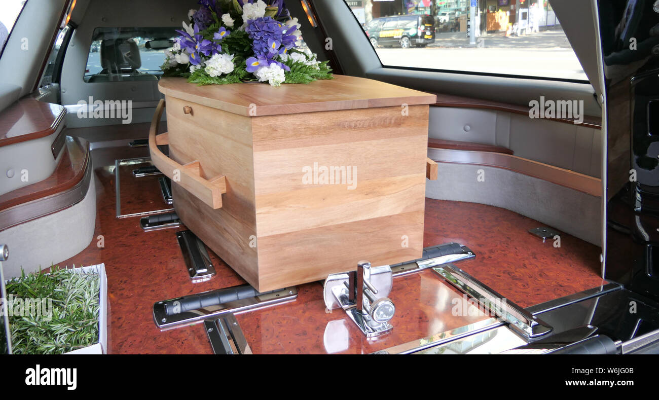 closeup shot of a funeral casket in a hearse or chapel or burial at ...