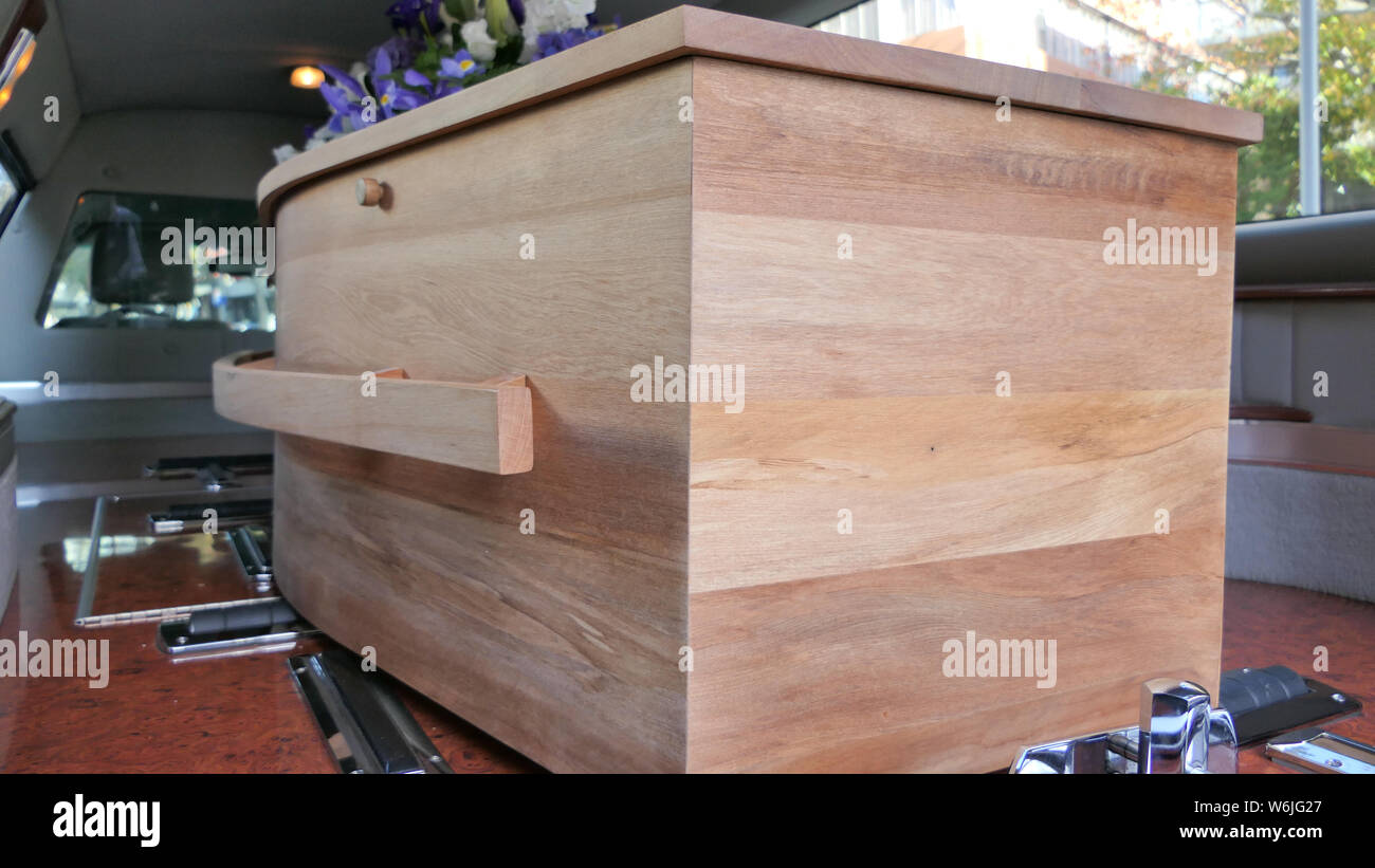 closeup shot of a funeral casket in a hearse or chapel or burial at ...