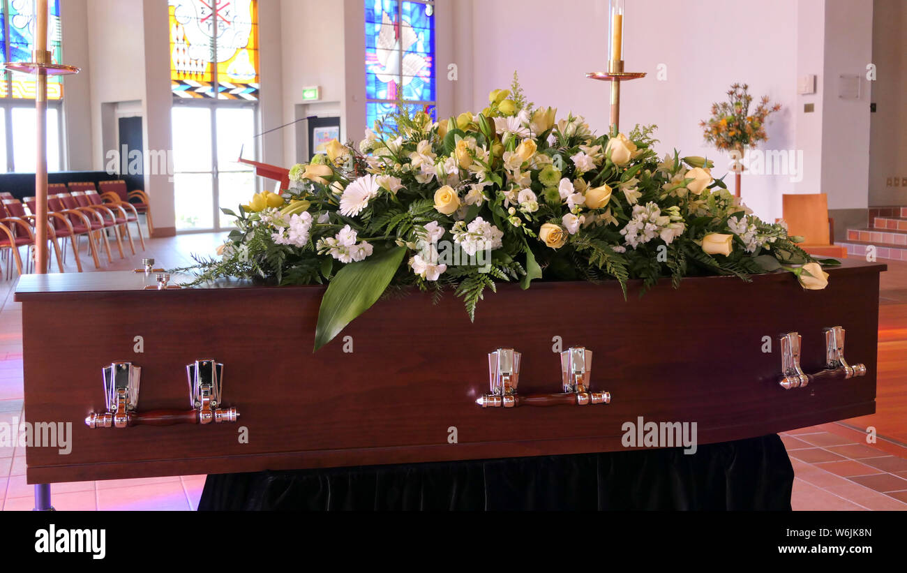 closeup shot of a funeral casket in a hearse or chapel or burial at ...