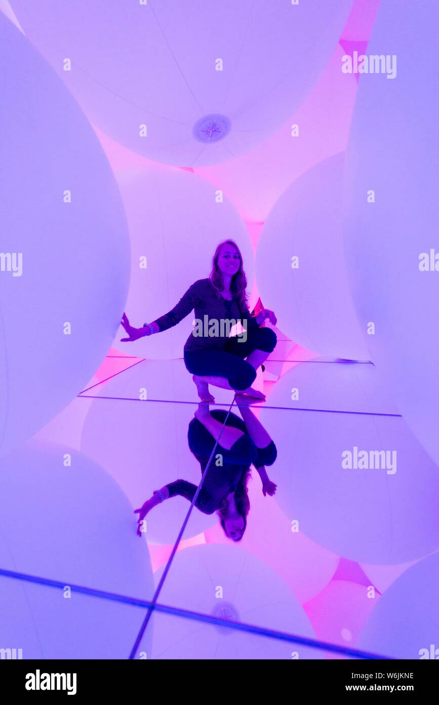 Young woman, Large illuminated spheres, LED installation in the Digital ...