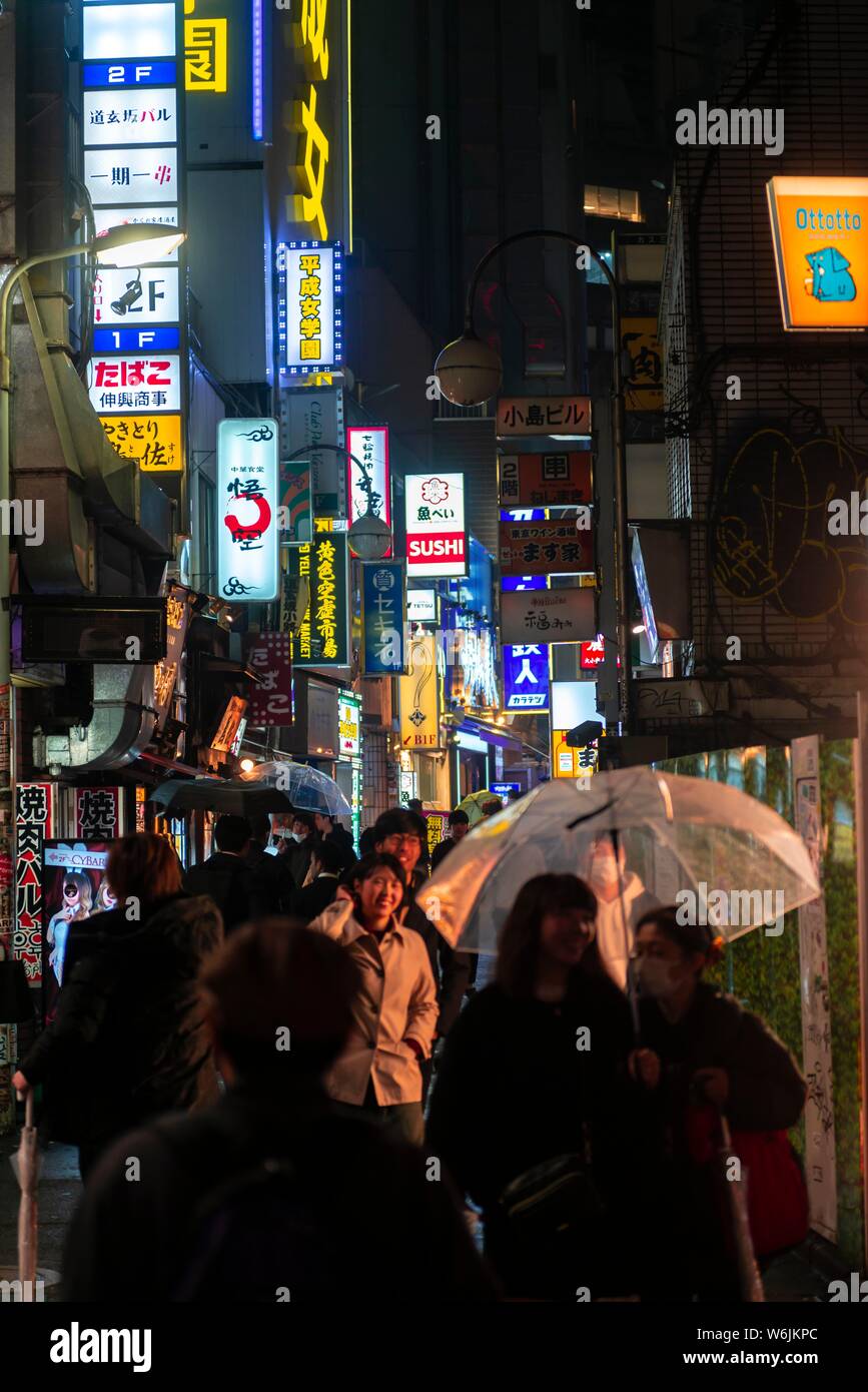 Pedestrian, lane with illuminated advertising and advertising signs at ...