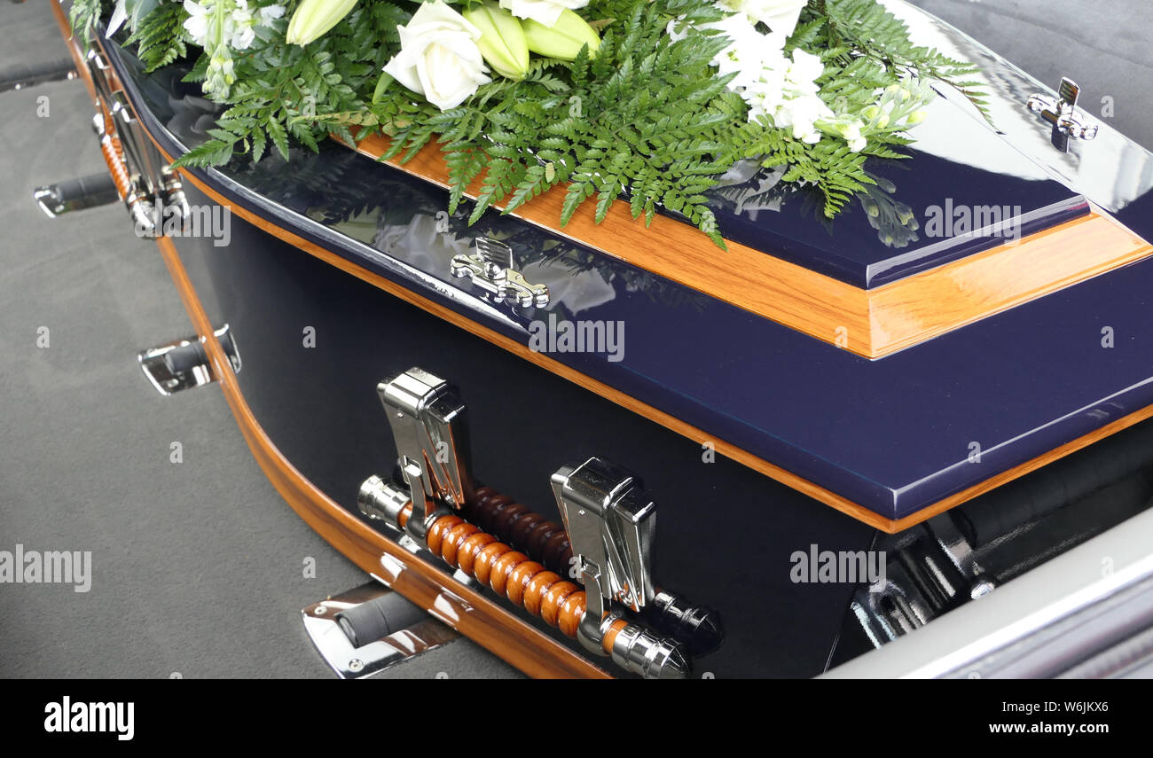 closeup shot of a funeral casket in a hearse or chapel or burial at ...
