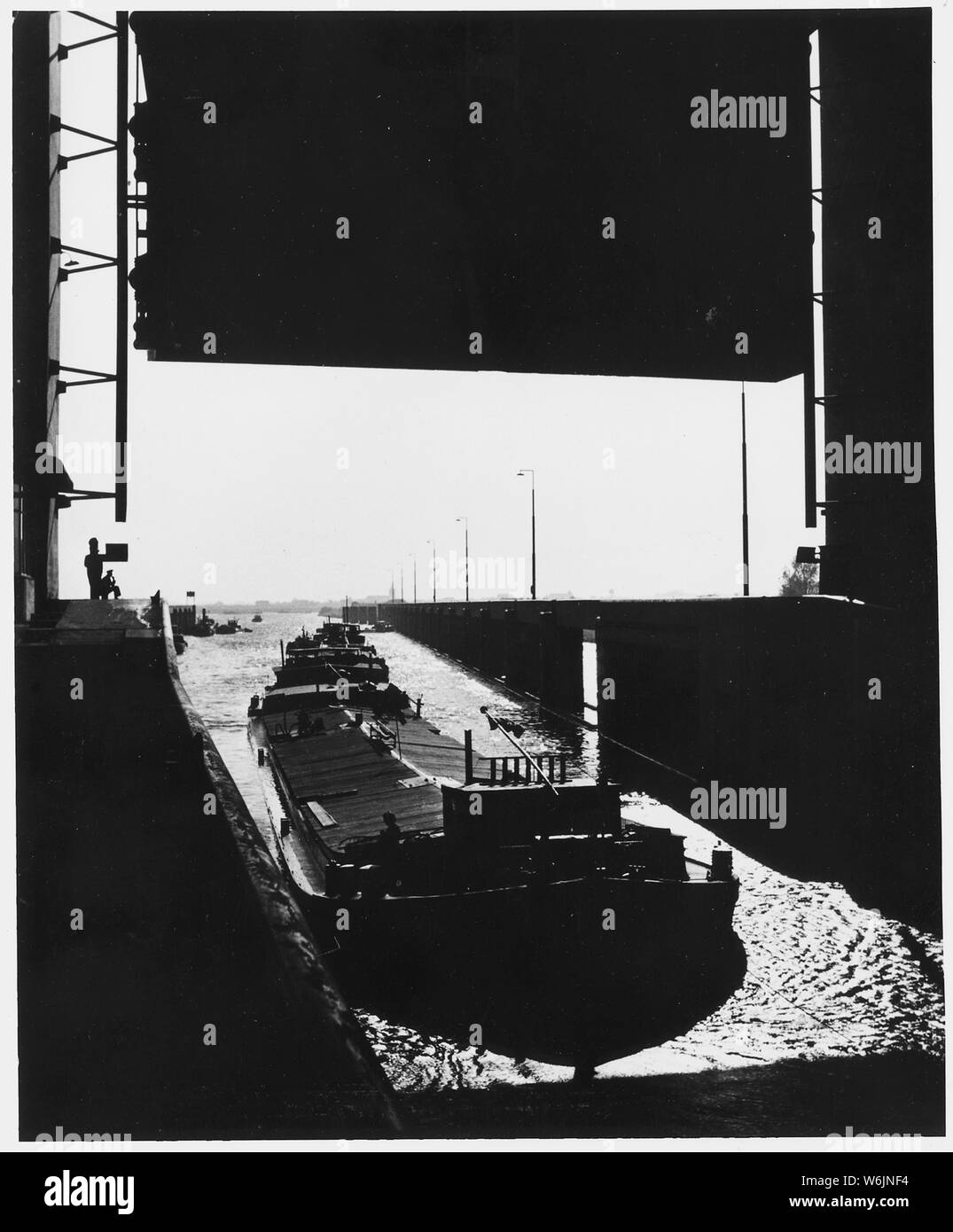 Netherlands. After World War II, a string of barges passes through the ...