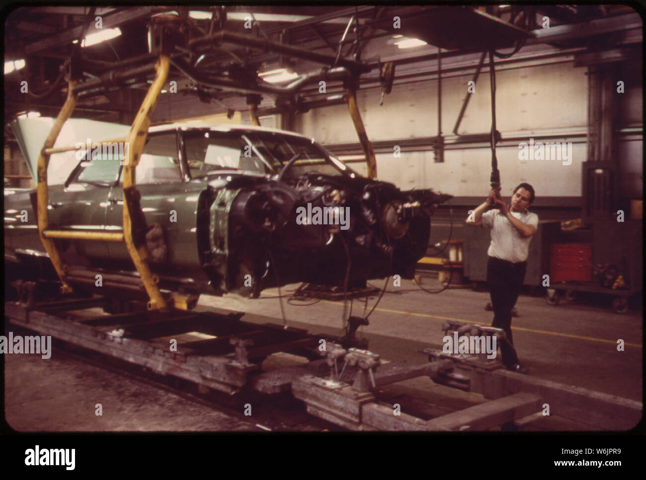 ON THE CADILLAC ASSEMBLY LINE--WIRING IS COMPLETE ON THIS BODY, AND NOW ...