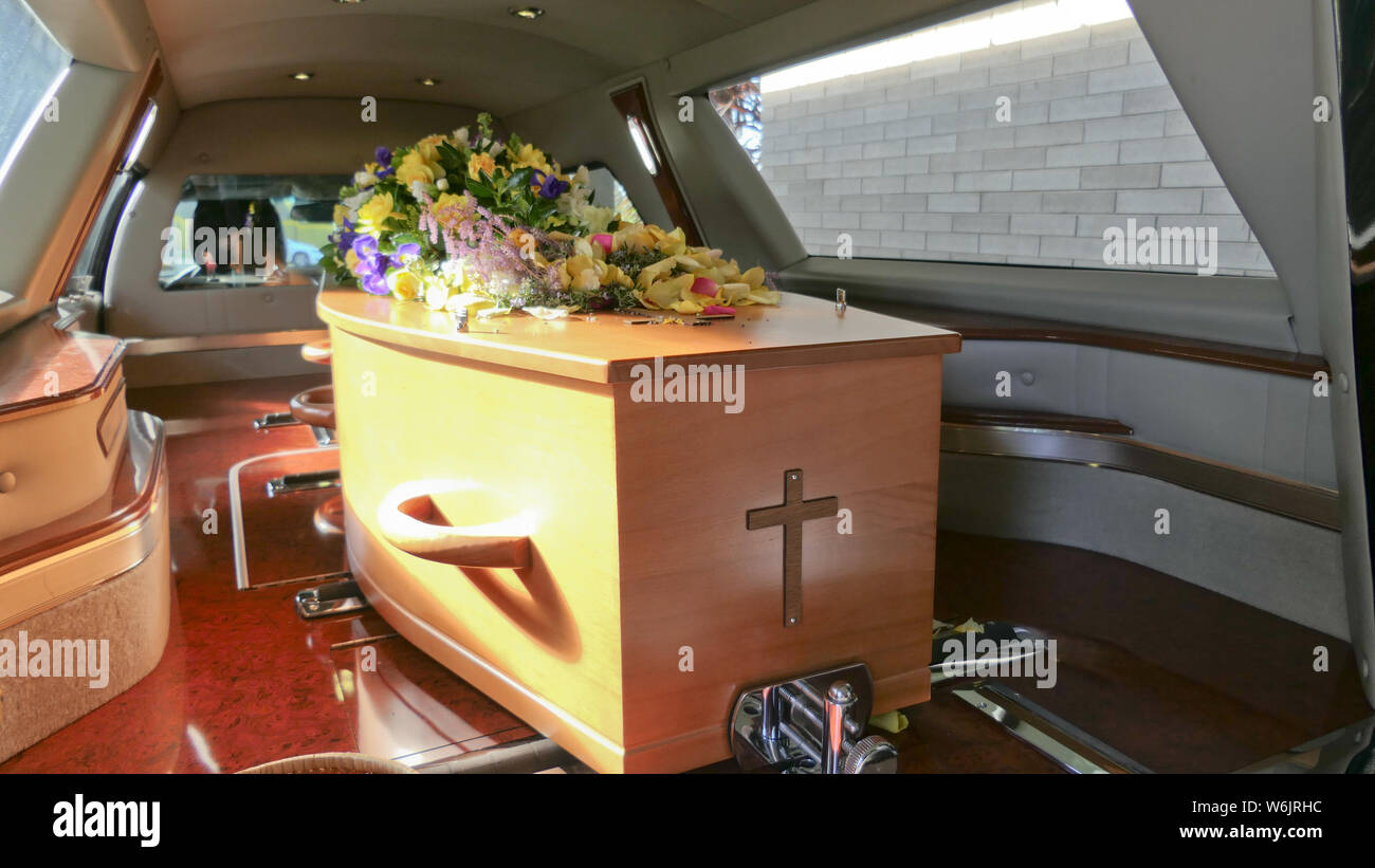 closeup shot of a funeral casket in a hearse or chapel or burial at ...