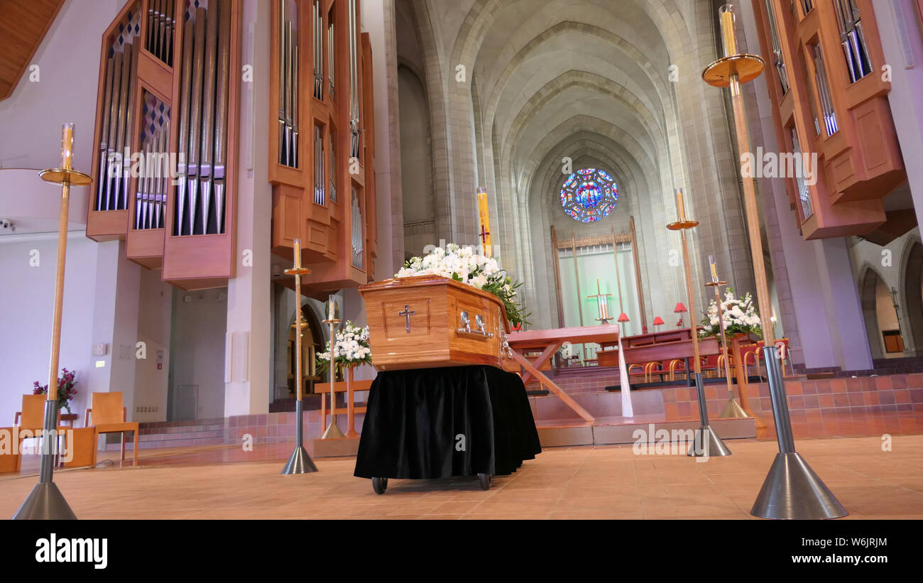closeup shot of a funeral casket in a hearse or chapel or burial at ...