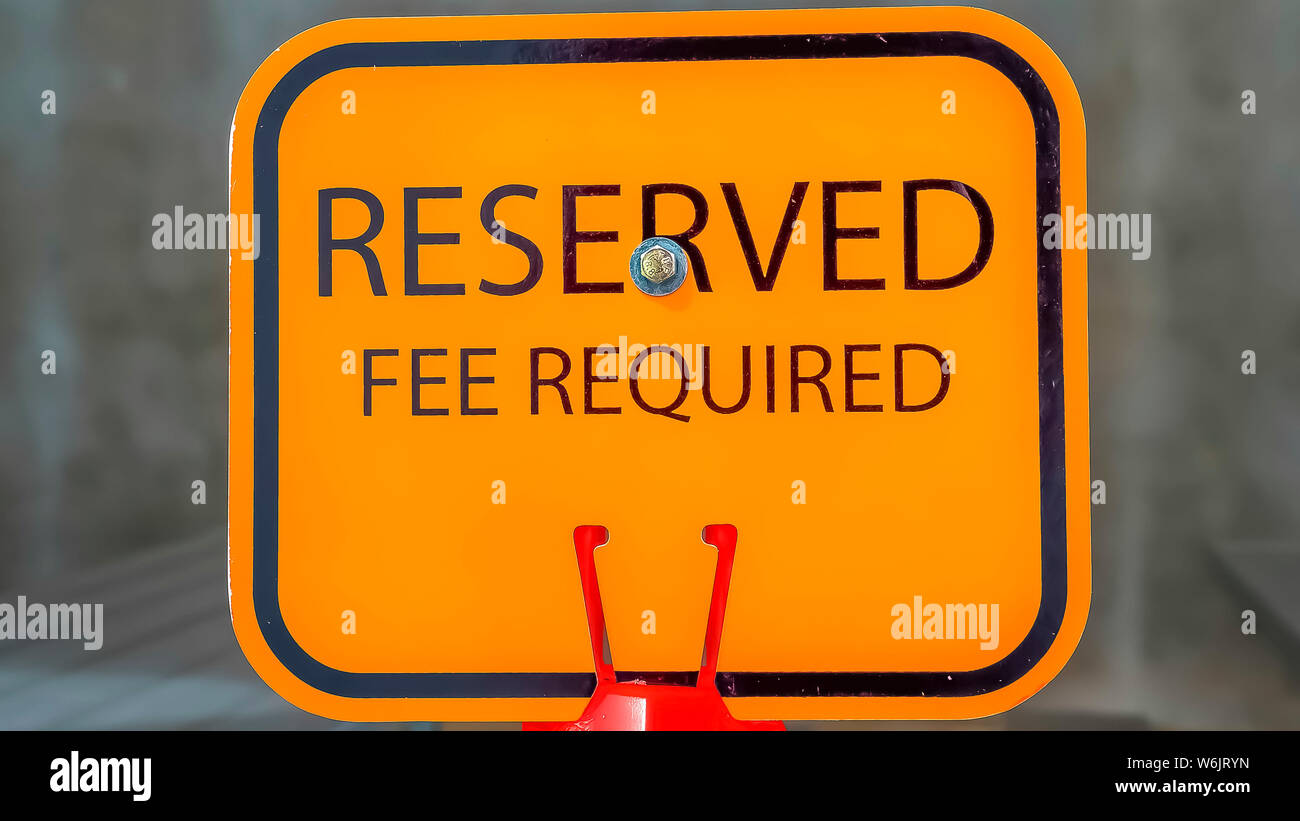 Panorama frame Close up of an orange Reserved sign with tables and ...