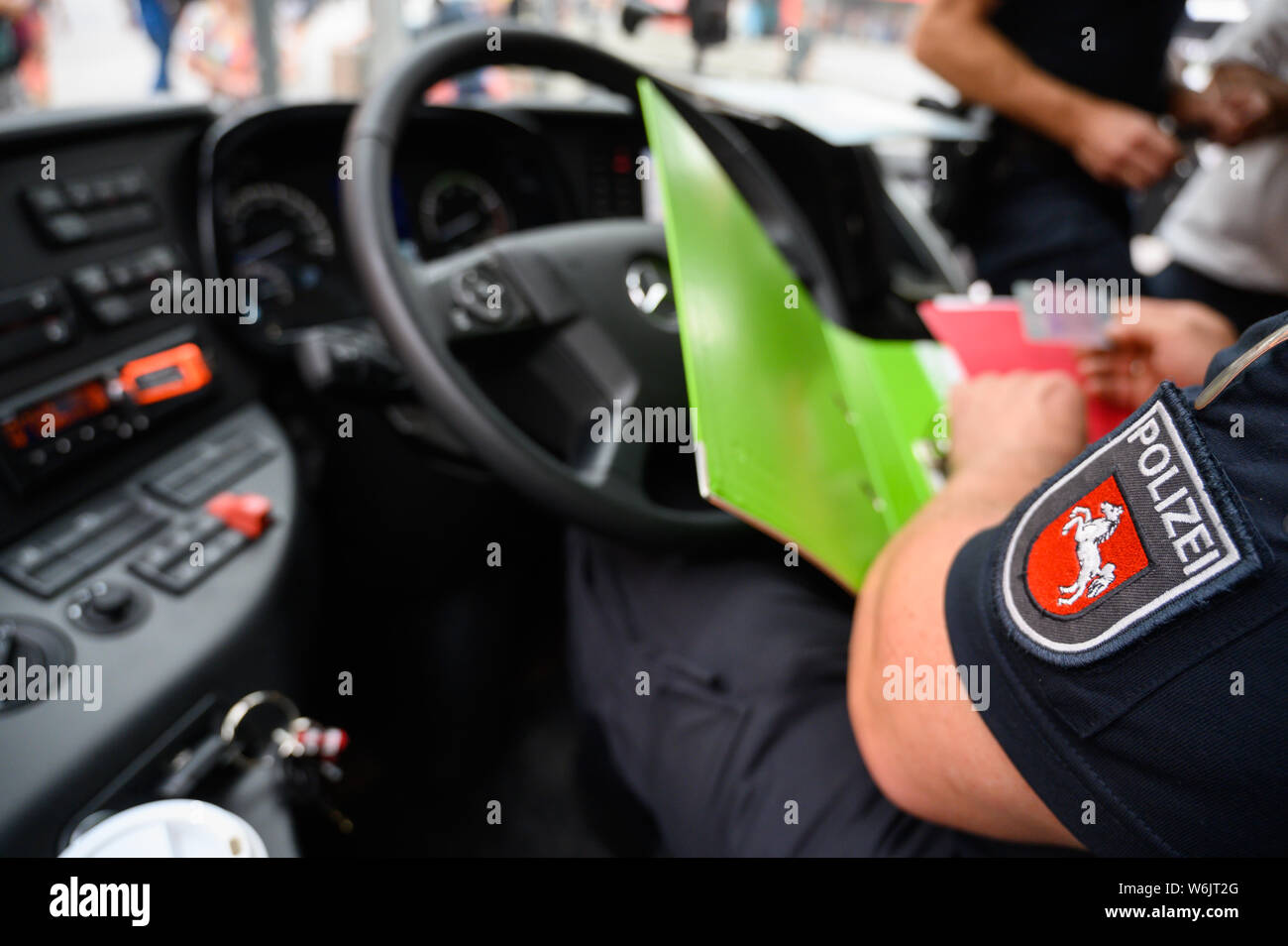 Hanover, Germany. 01st Aug, 2019. A policeman checks the driving ...