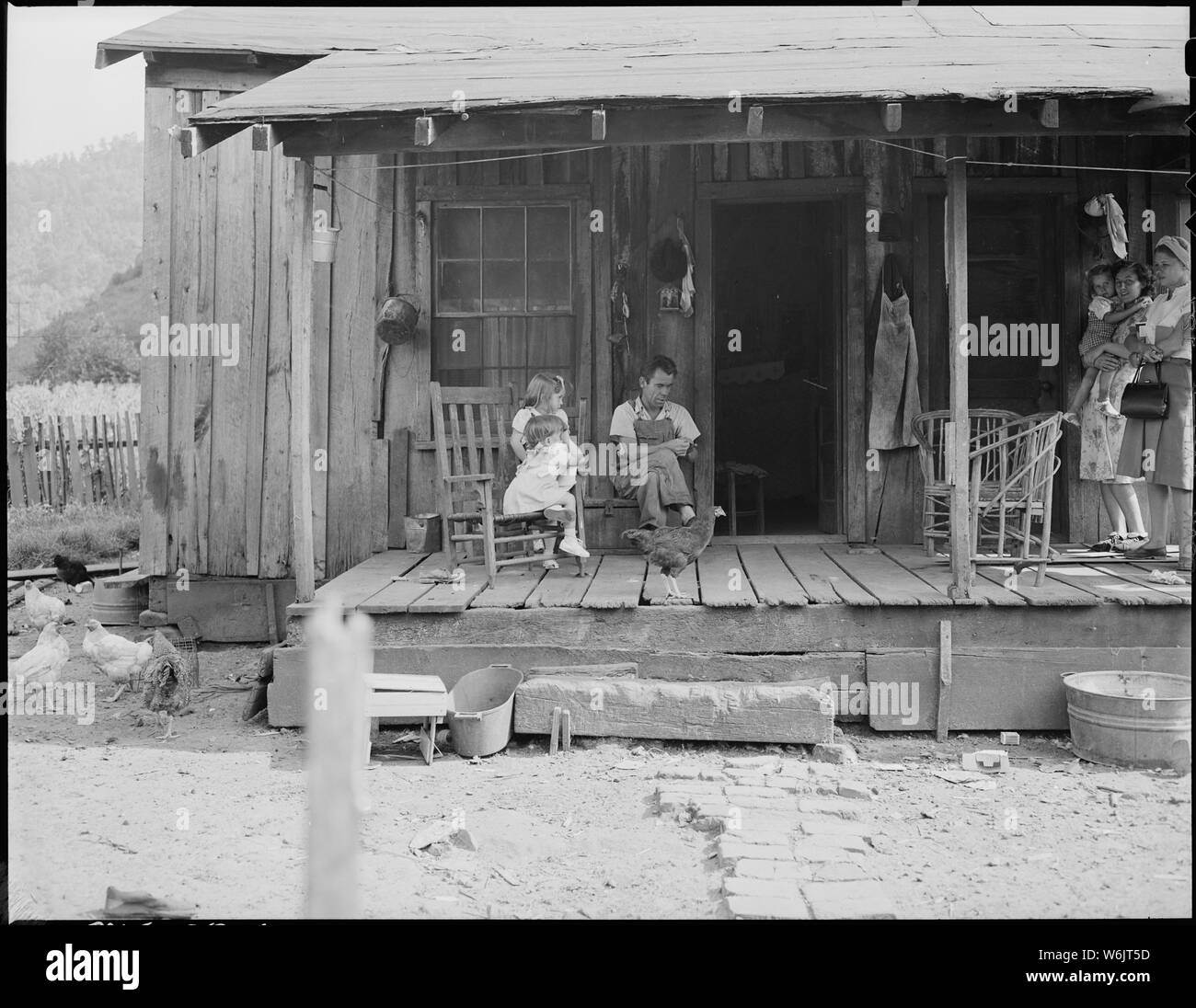 Oliver Hinkle, disabled mine, and children on the front porch of his ...
