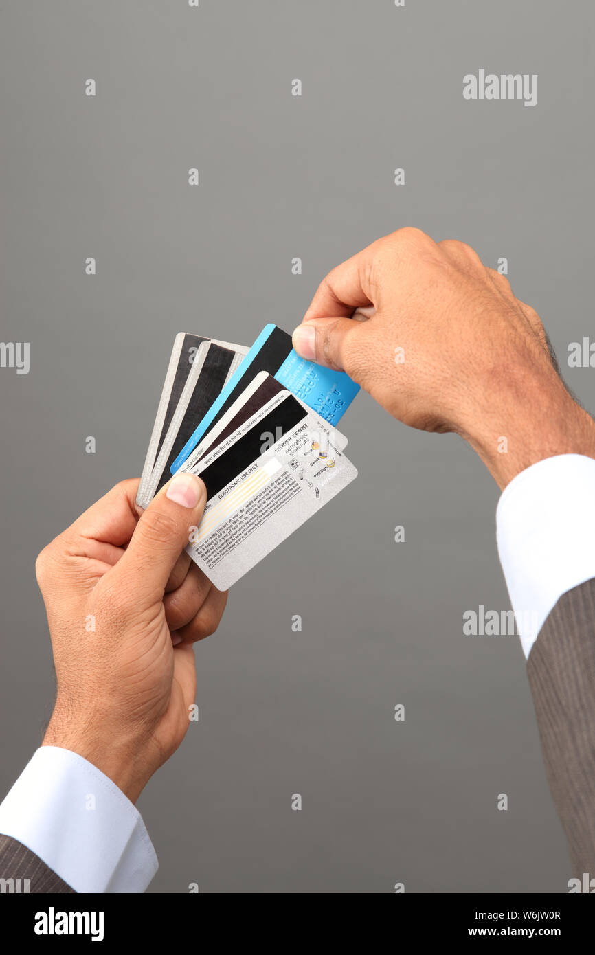 Man's hand holding credit cards Stock Photo - Alamy