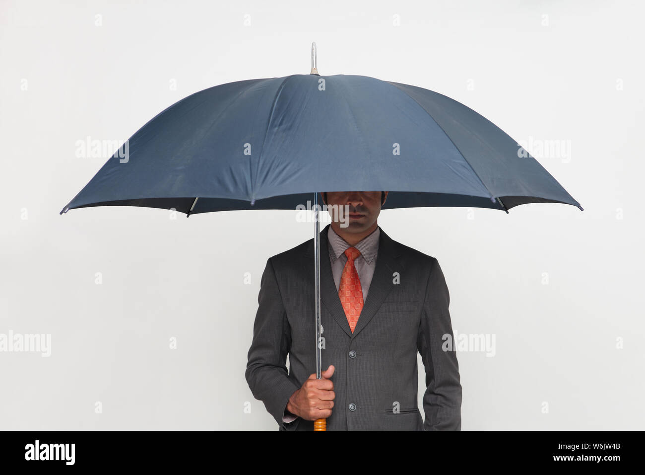 Person sheltering under an umbrella hi-res stock photography and images ...