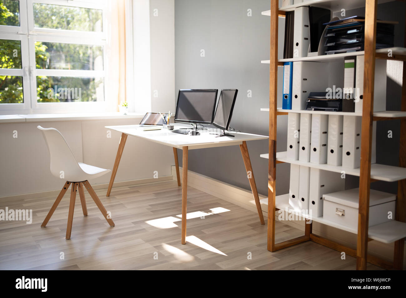 Desk laptop computer monitor by window hi-res stock photography and ...
