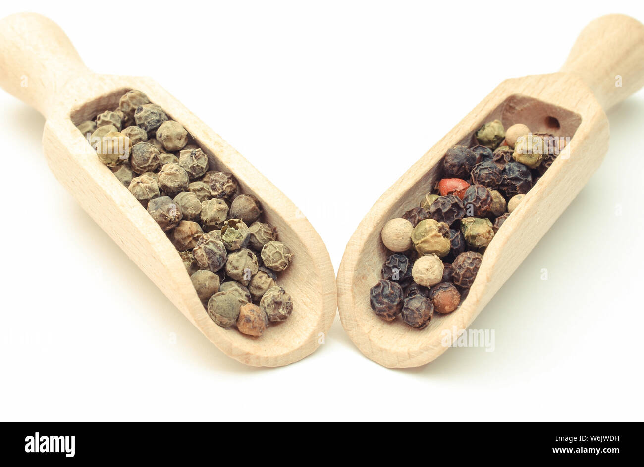 Colored and green pepper with wooden scoop or spoon on white background ...