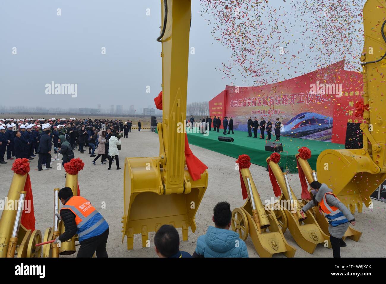 Construction vehicles are standby at the construction site of a rail ...