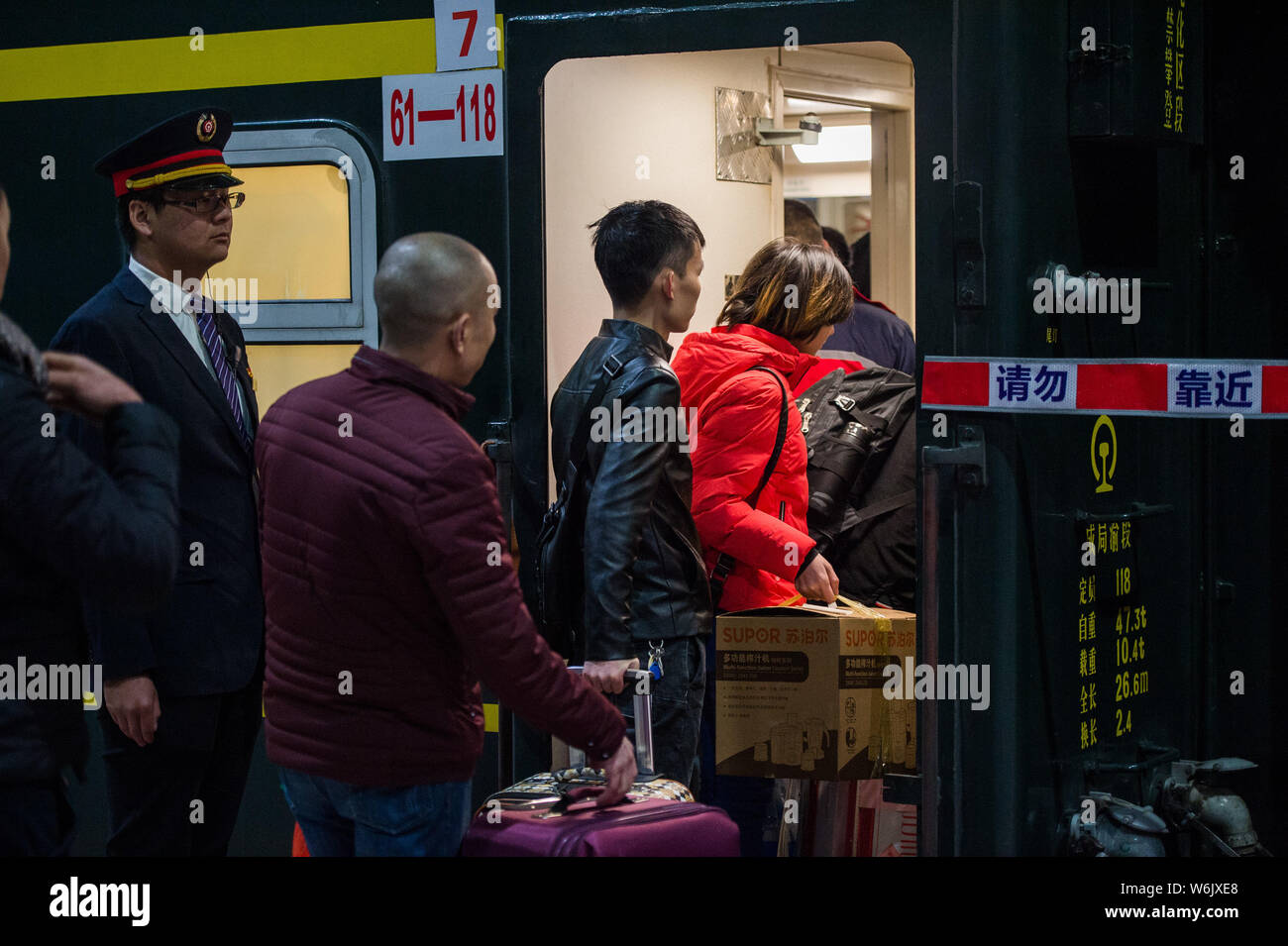 Chinese passengers board a train at the Shenzhendong Railway Station during the Spring Festival ...