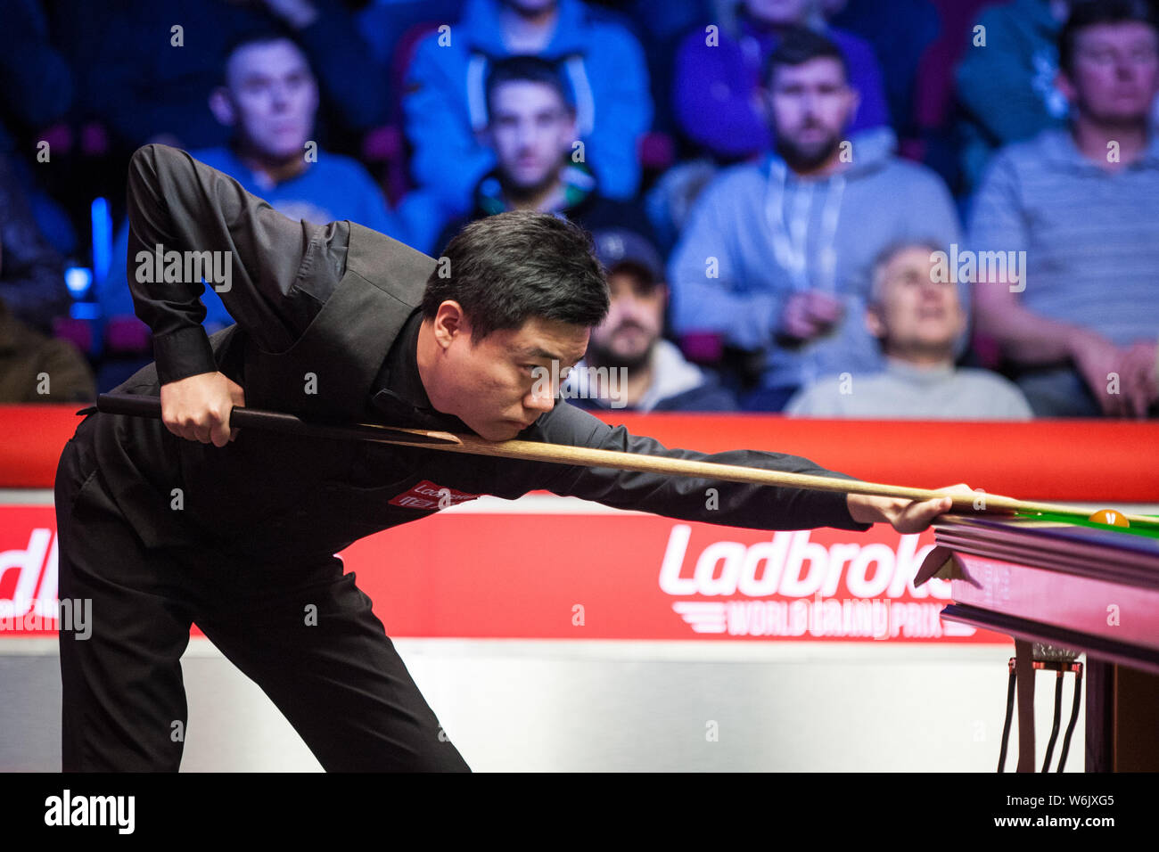 Ding Junhui of China plays a shot to Mark Selby of England in their semi-final match during the ...