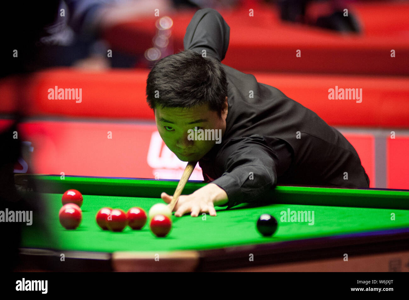 Ding Junhui of China plays a shot to Mark Joyce of England in their ...