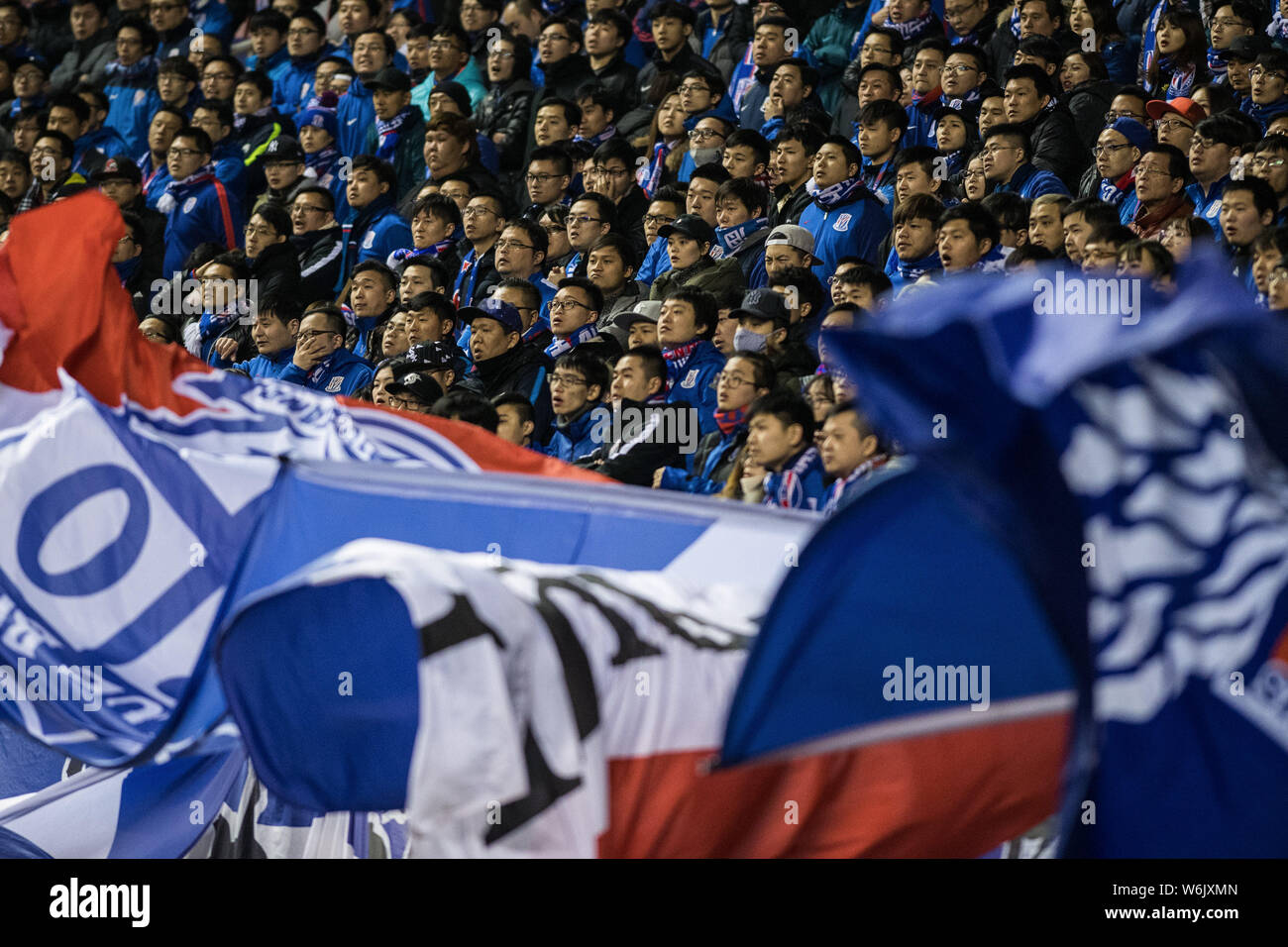 Chinese fans shout slogans to show their support for China's Shanghai ...