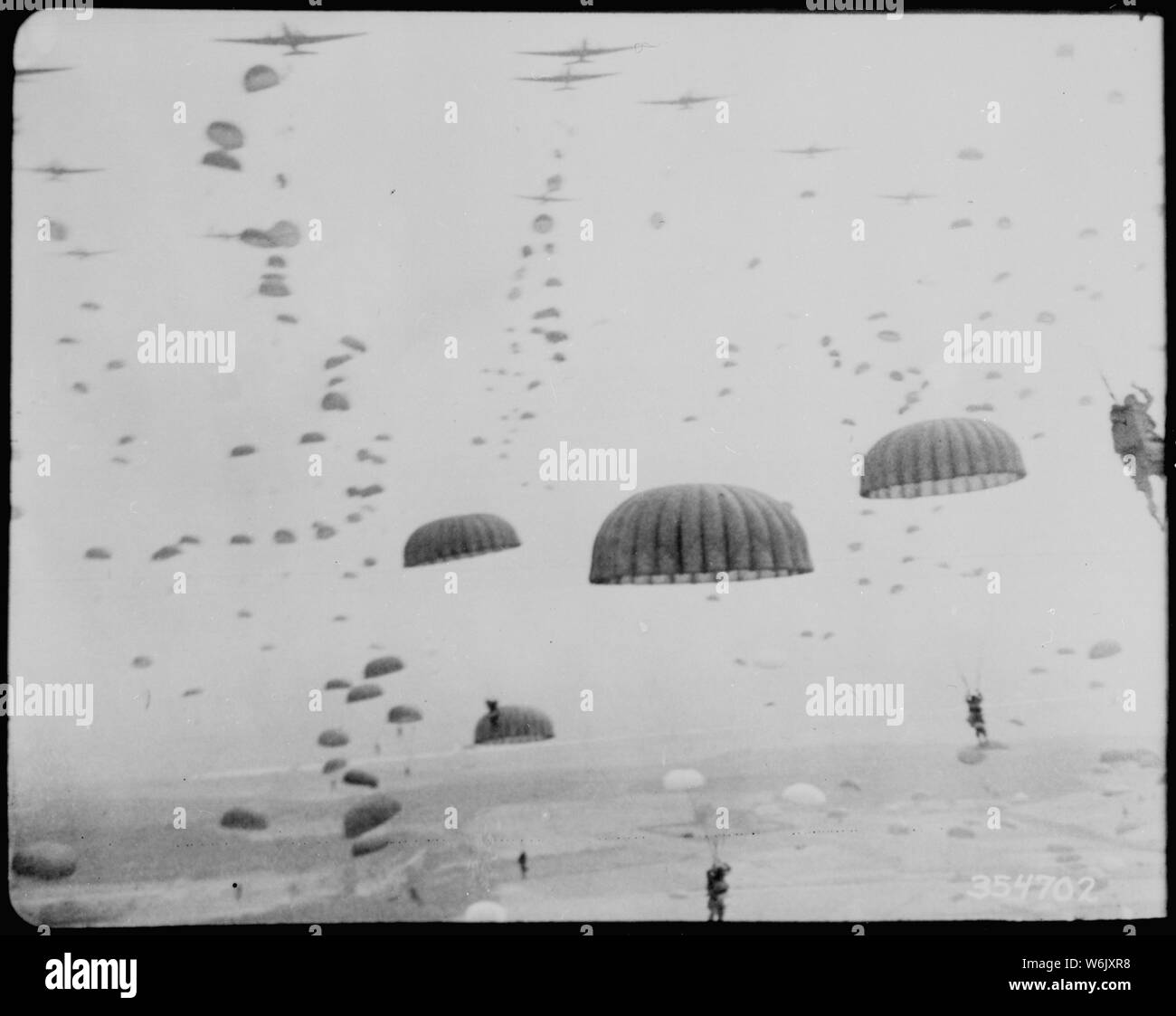 Parachutes open overhead as waves of paratroops land in Holland during ...