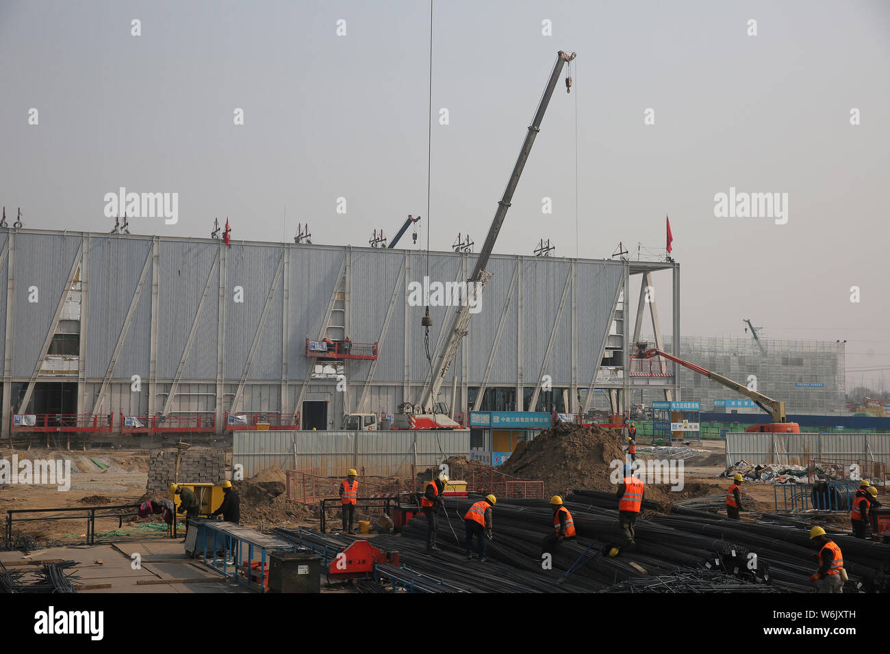 Workers labor at the Xiong'an Civic Service Center, the first ...
