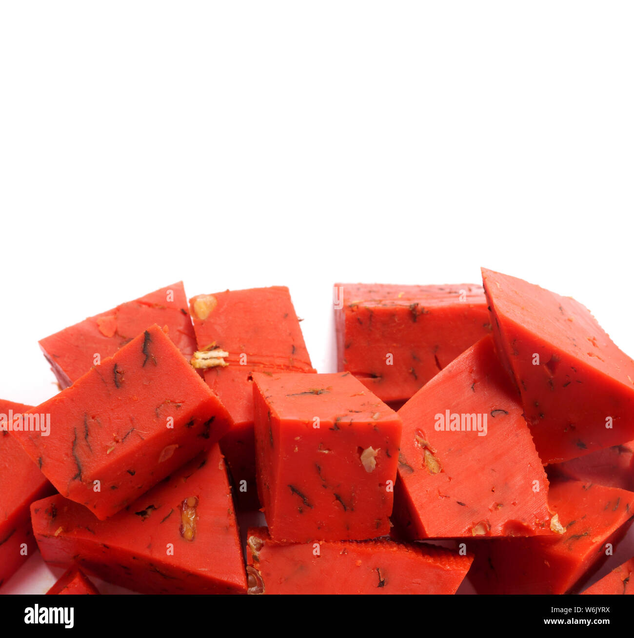 Dutch red cheese. Piece solid red Pesto cheese with tomatoes and ...