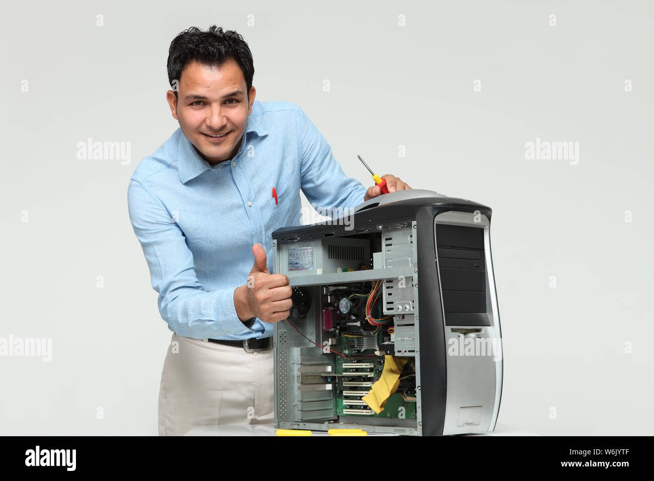 Computer engineer repairing CPU and showing thumbs up Stock Photo - Alamy
