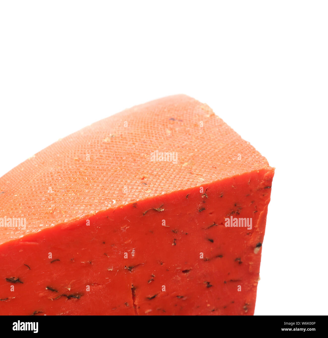 Dutch red cheese. Piece solid red Pesto cheese with tomatoes and ...