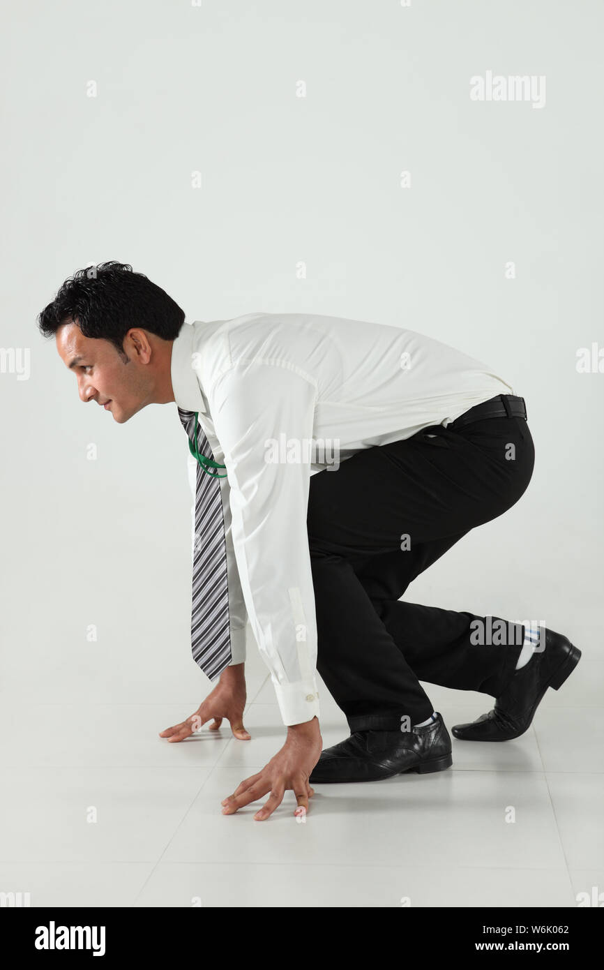 Businessman in race start position Stock Photo - Alamy
