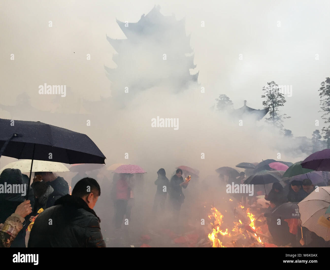 Chinese worshippers burn incense sticks to pray for wealth and ...