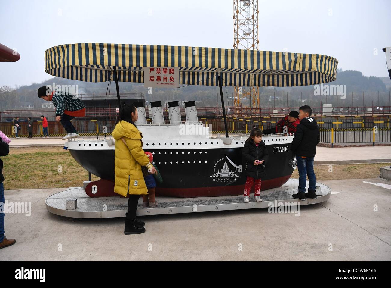 Visitors look at a model of the Titanic passenger liner in Daying ...