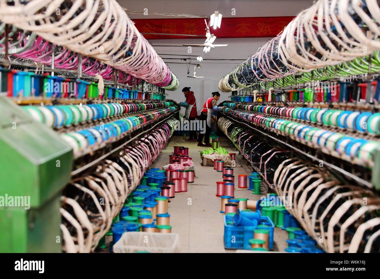 Female Chinese workers handle production of silk to be exported at a ...
