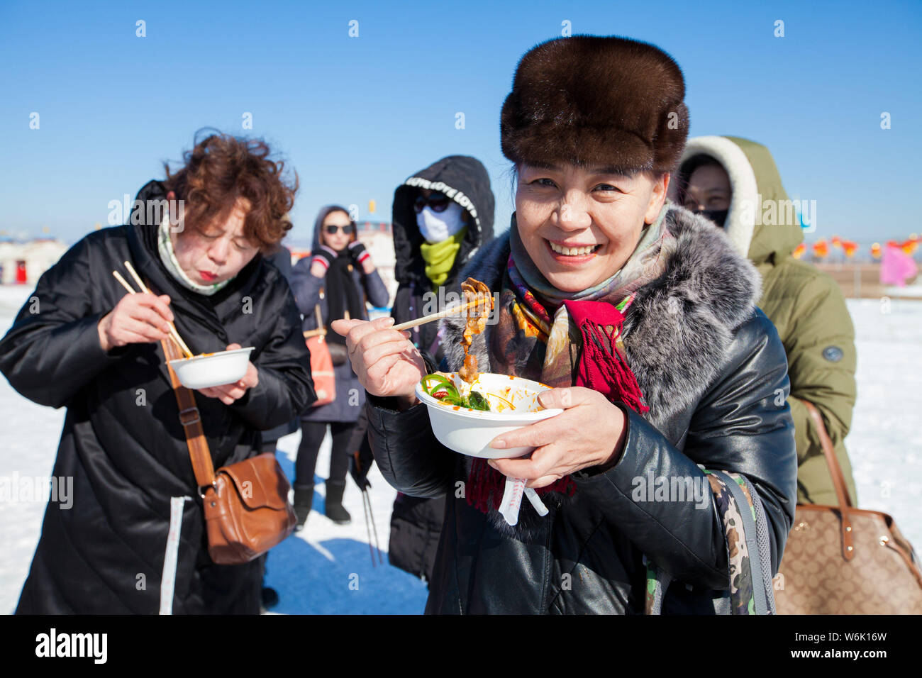 Tourists enjoy a giant hot pot during the first Ice and Snow Hotpot ...