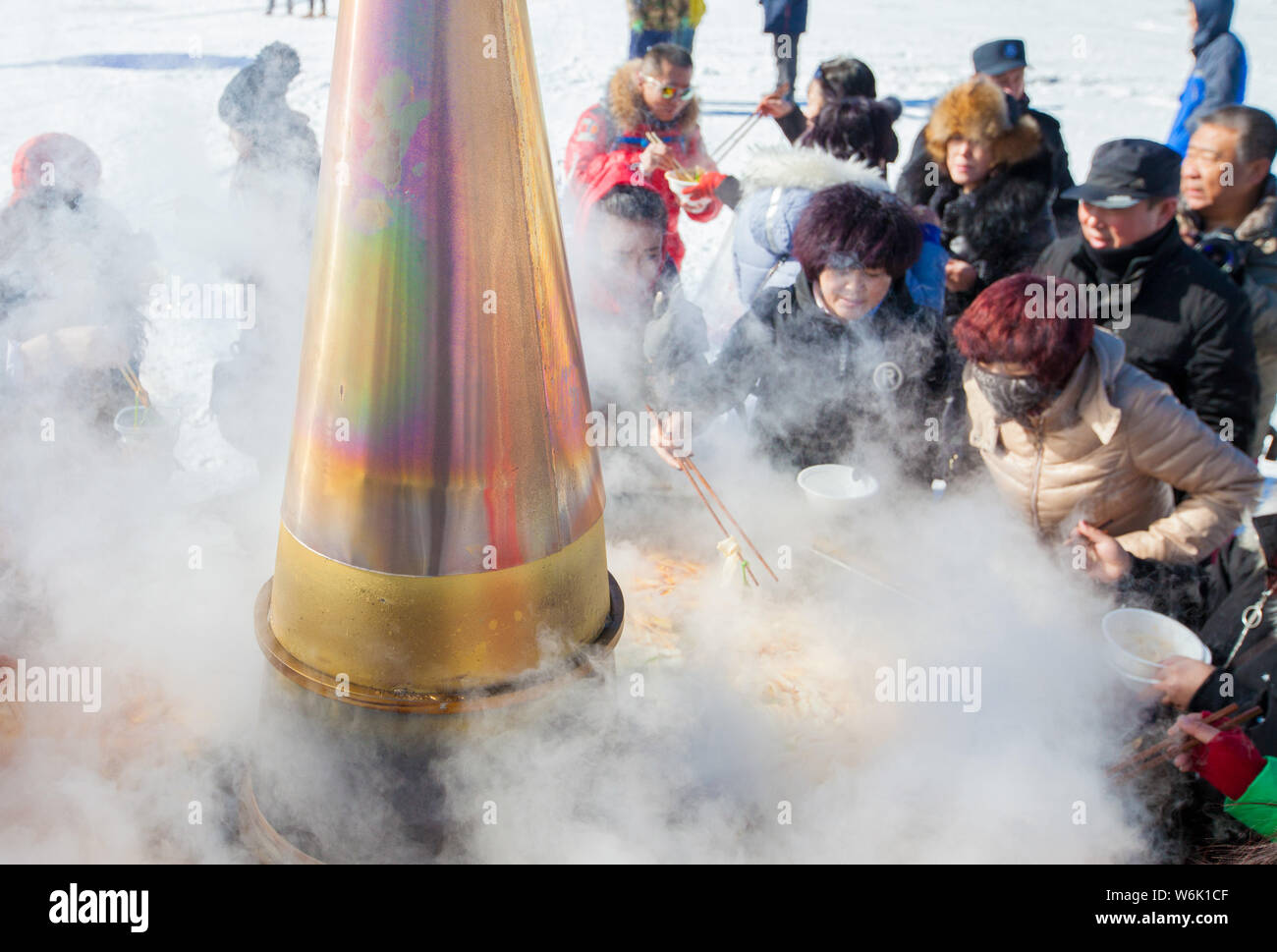 Tourists enjoy a giant hot pot during the first Ice and Snow Hotpot ...