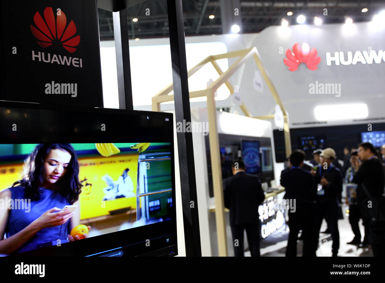 --FILE--People visit the stand of Huawei during an exhibition in ...