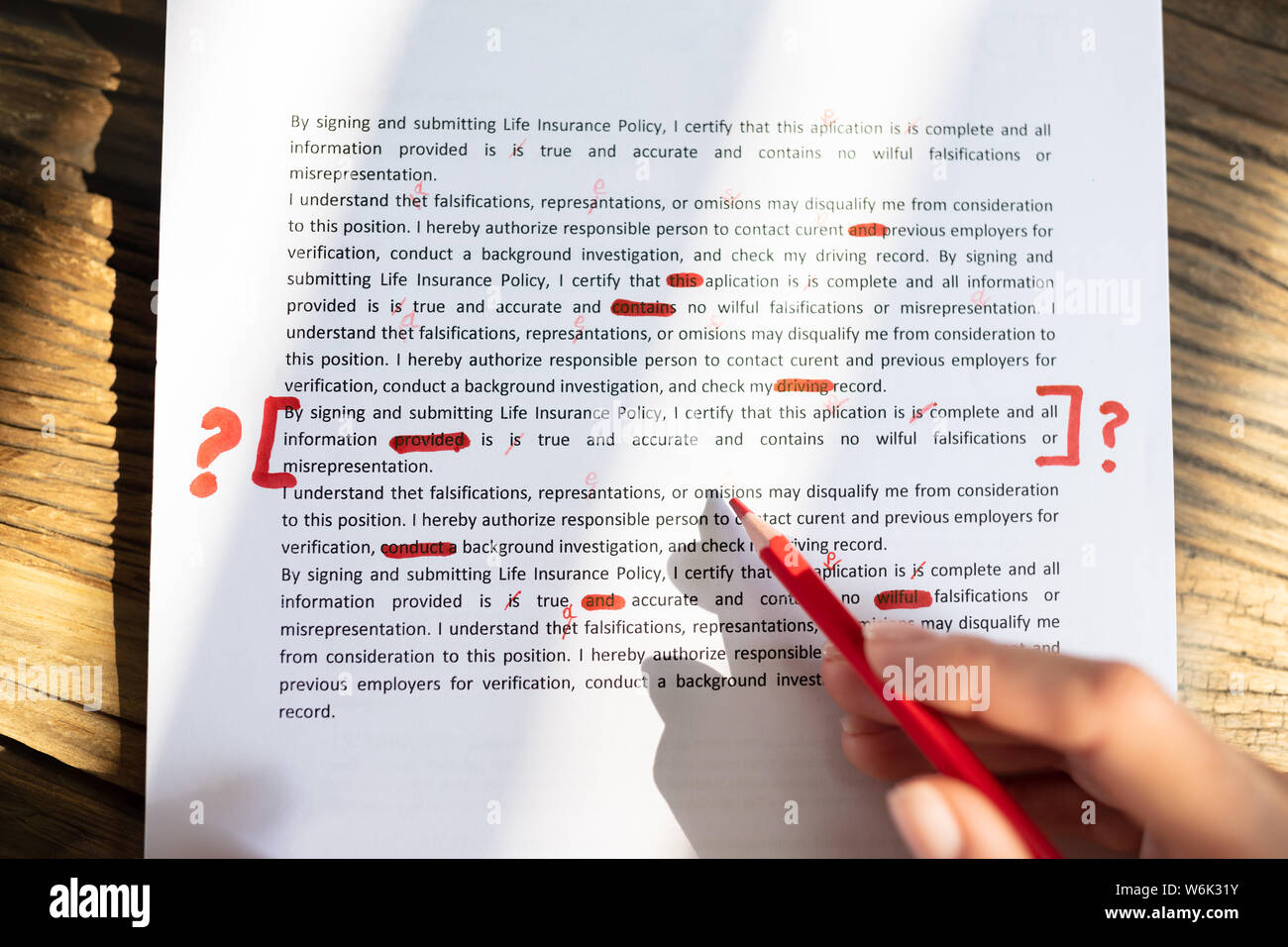 Close-up Of A Person's Hand Marking Error With Red Marker On Document ...