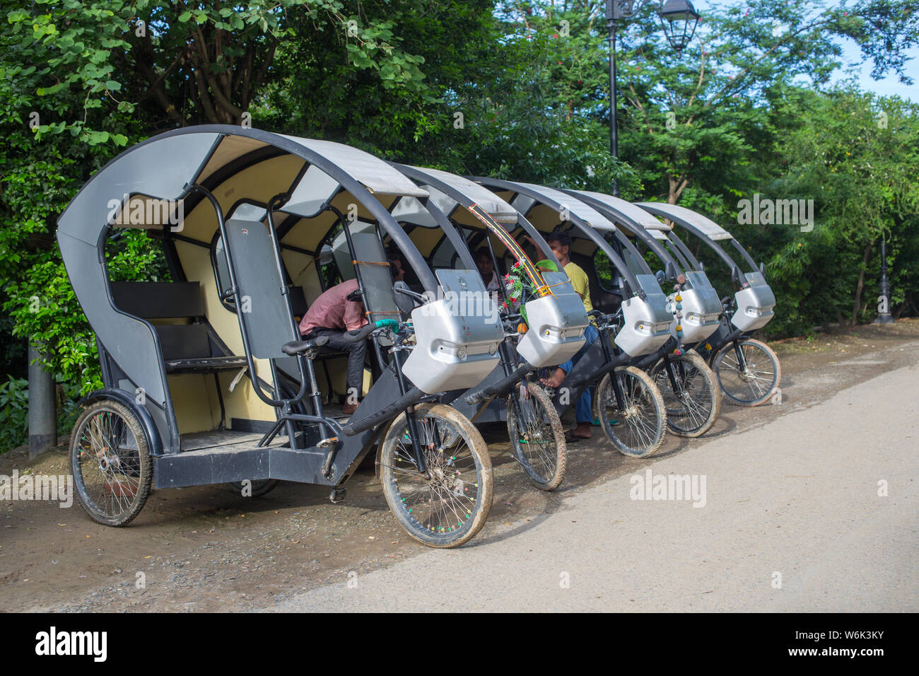 A bunch of bicycle rickshaws in the entrance to Lumbini Sanskritik ...